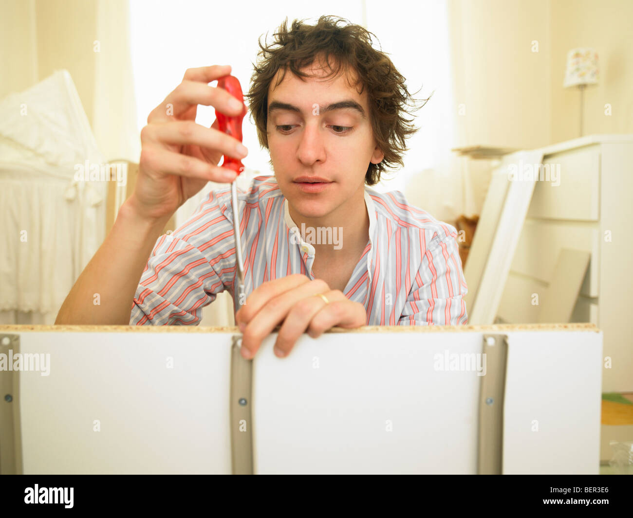 Man building furniture Stock Photo - Alamy