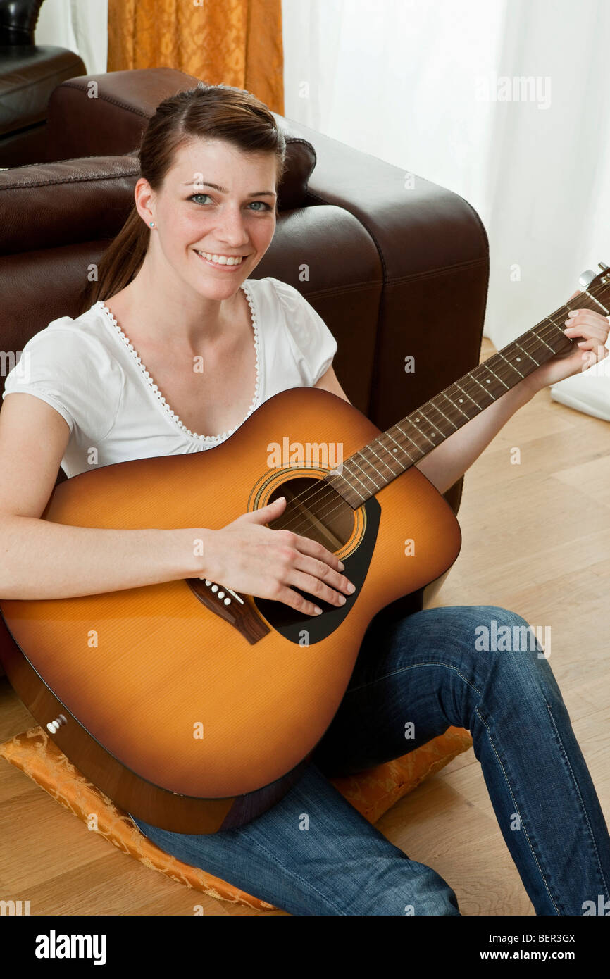 Young woman playing the guitar Stock Photo - Alamy