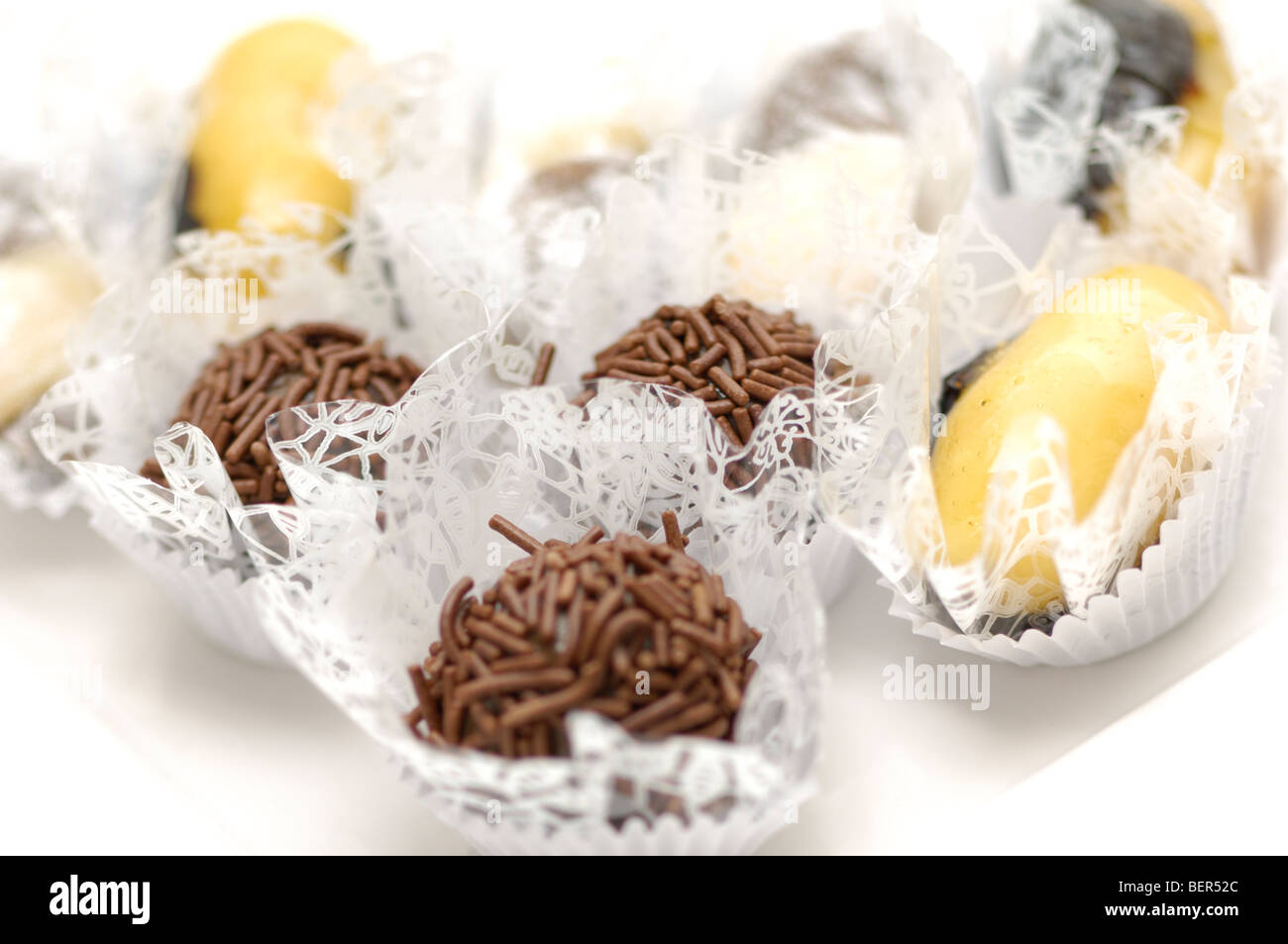 Chocolates and sweets in white paper cups Stock Photo - Alamy