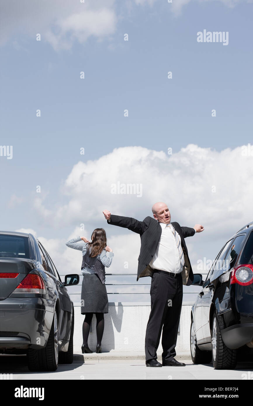 man and woman stretching between cars Stock Photo - Alamy