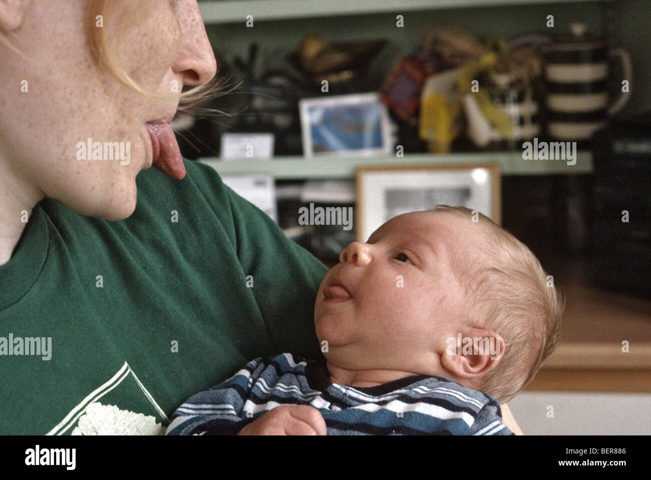 Mother with two week old baby communicating by imitation Stock Photo ...