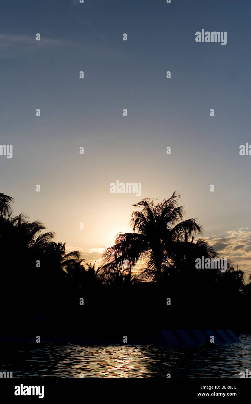 The sun sets over a resort pool in the Mexican Riviera Maya Stock Photo ...