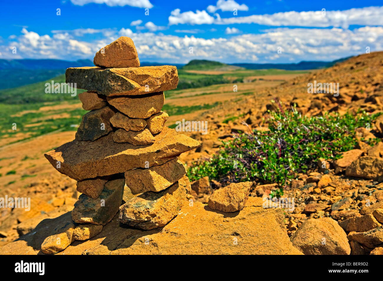An inuksuk on a steep hill above the Tablelands Trail in Tablelands ...