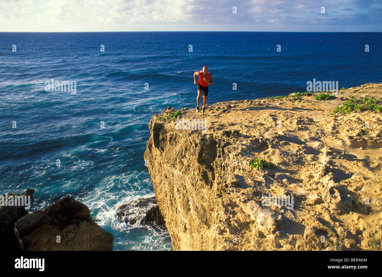 Man running along edge of seaside cliff, Kauai, Hawaii Stock Photo - Alamy