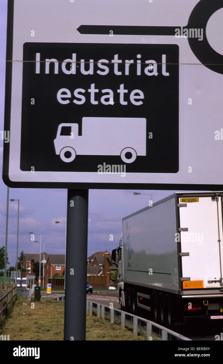 articulated lorry passing road sign giving directions for lorry drivers ...