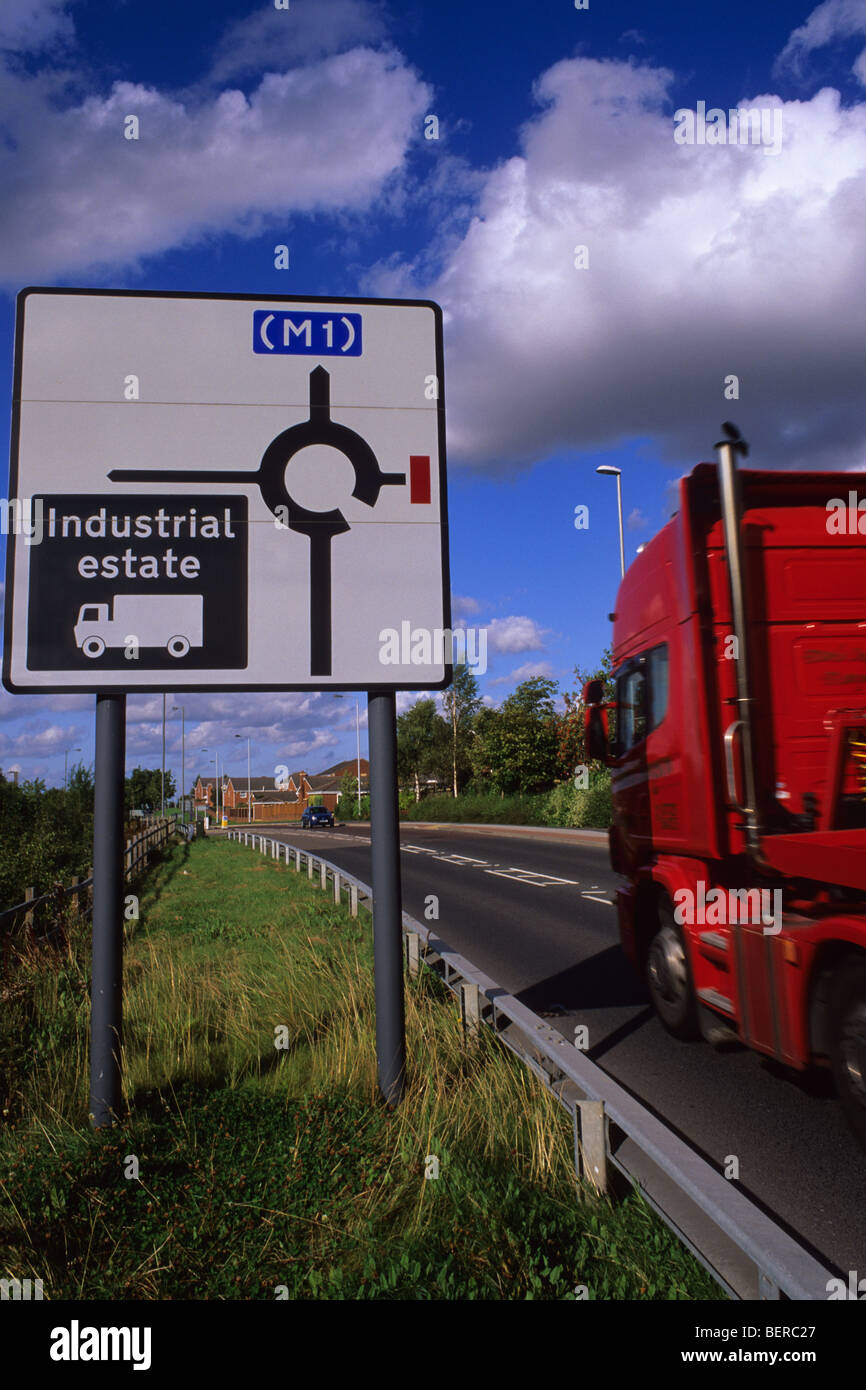 articulated lorry passing road sign giving directions for lorry drivers ...