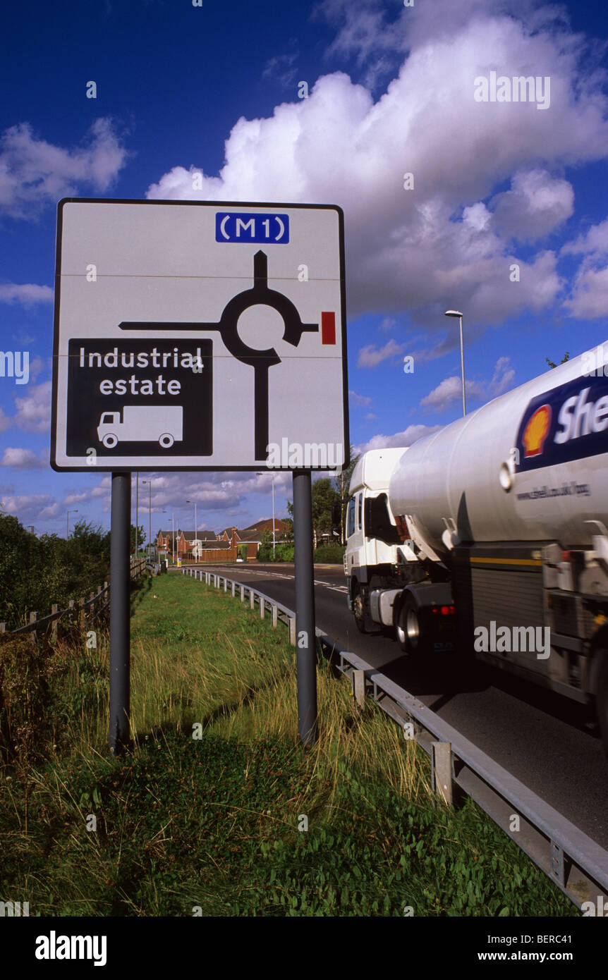articulated lorry passing road sign giving directions for lorry drivers ...