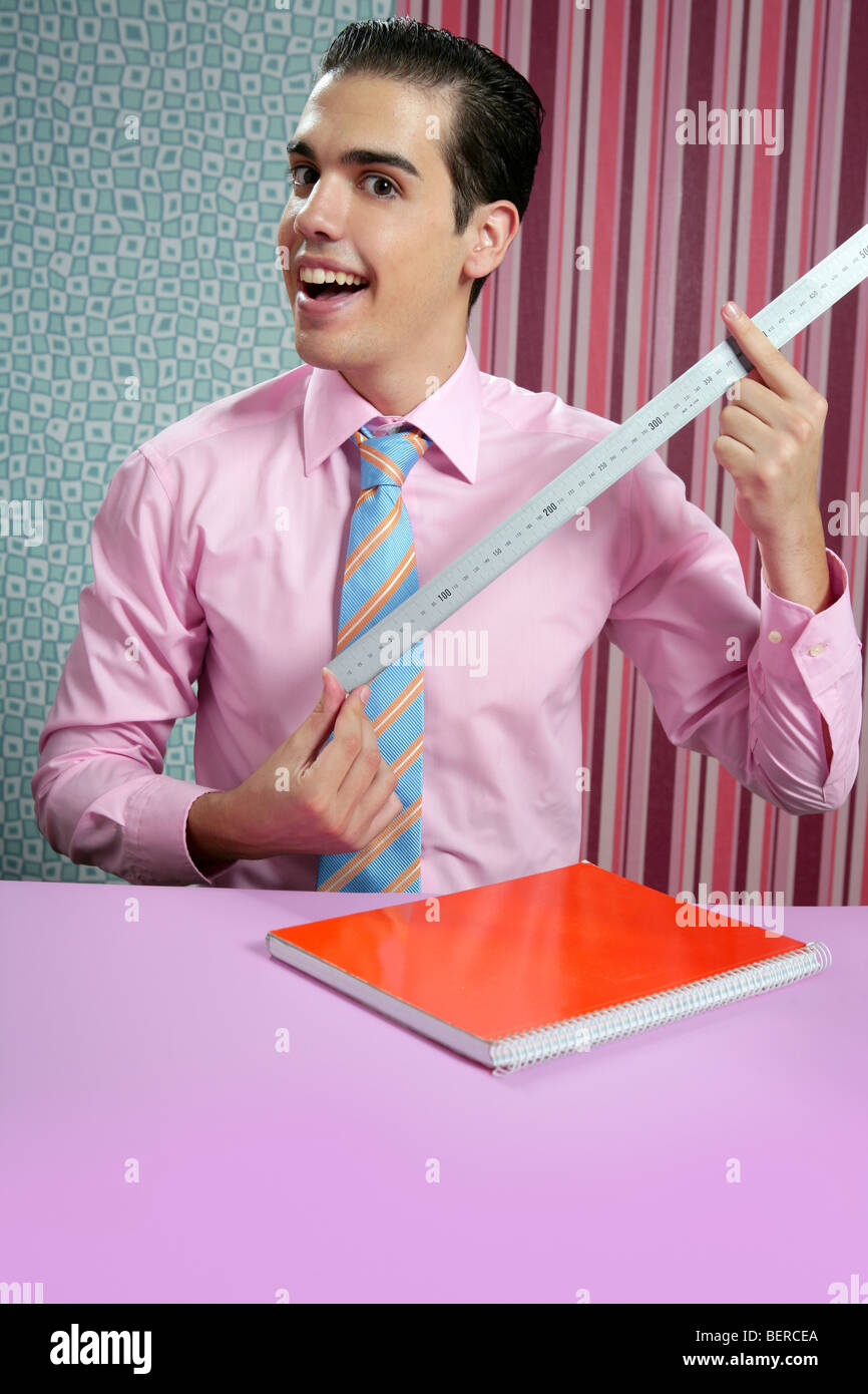 Funny young businessman with measuring ruler, size matter metaphor ...