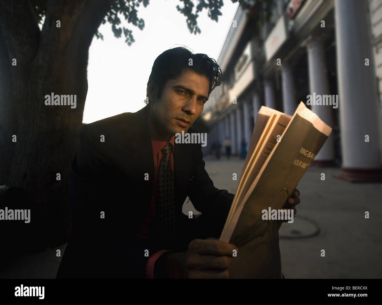 Man with newspaper Stock Photo - Alamy