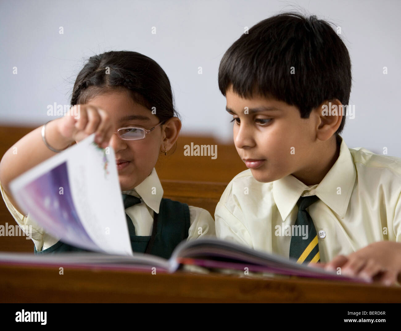 Students reading a book Stock Photo - Alamy