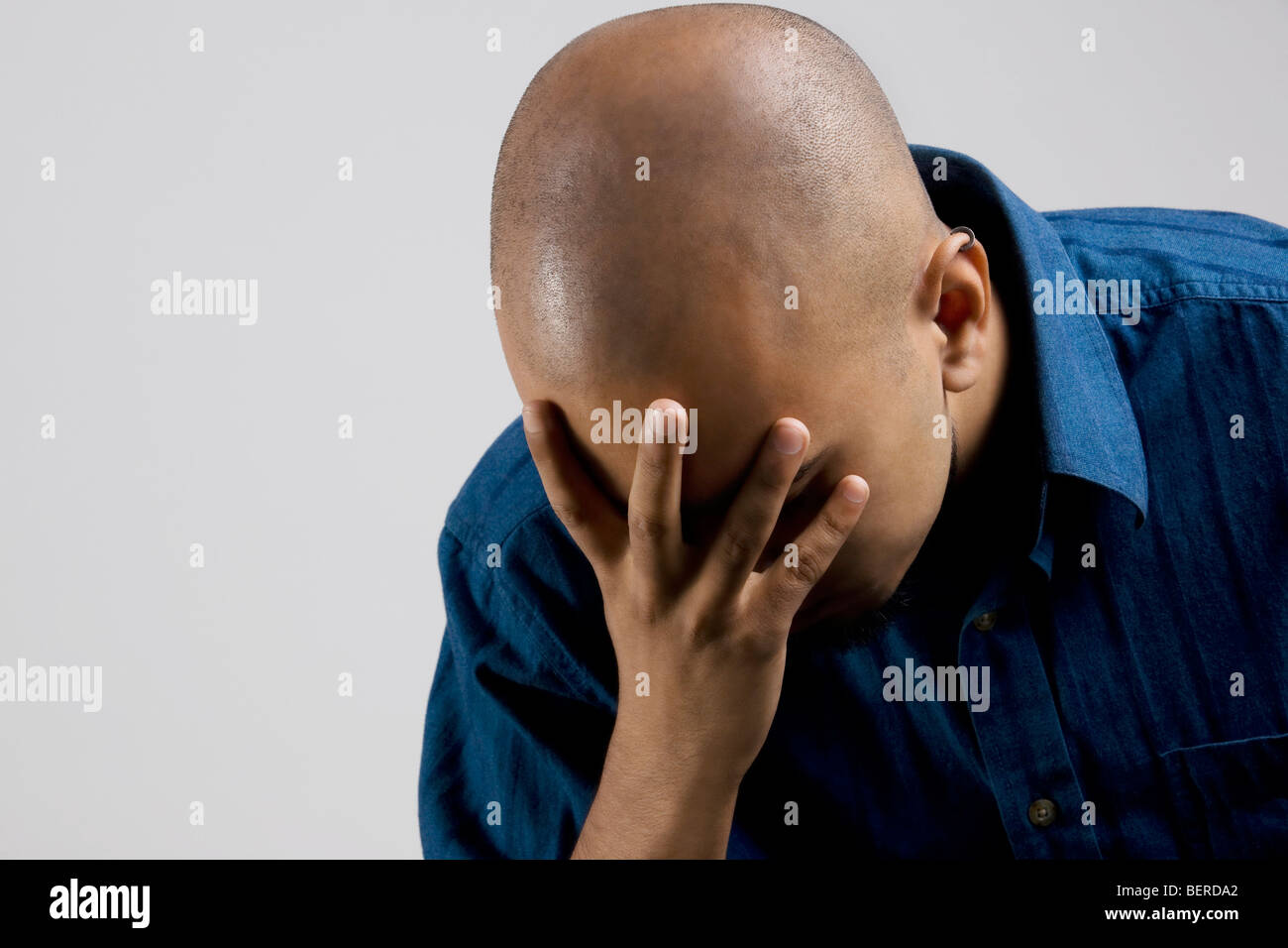 Man with his head in his hands Stock Photo - Alamy