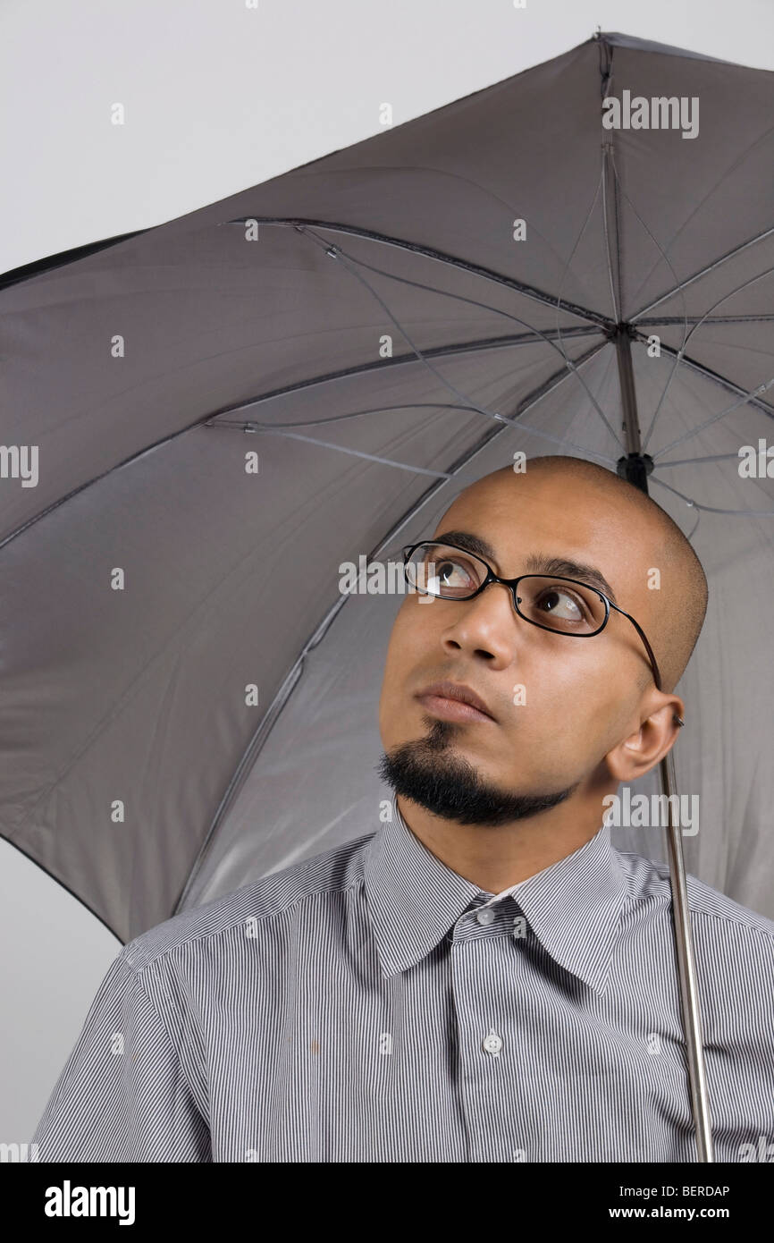 Man holding an umbrella Stock Photo - Alamy