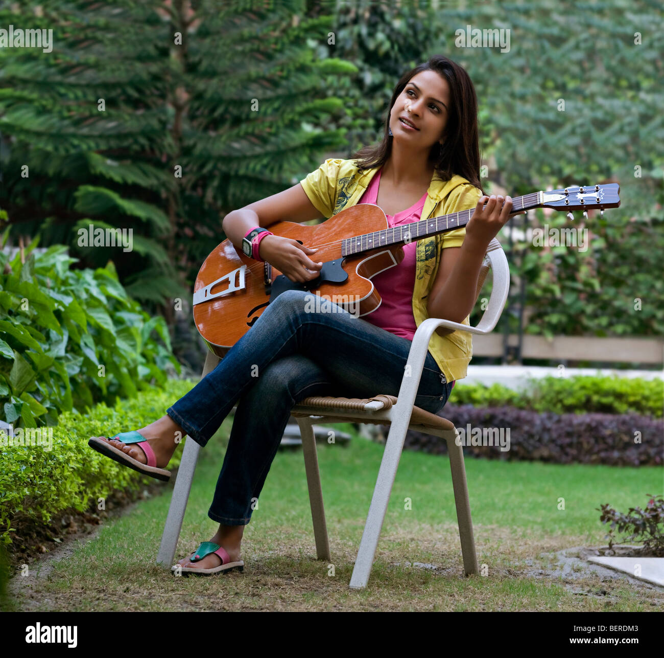 Woman playing the guitar Stock Photo - Alamy
