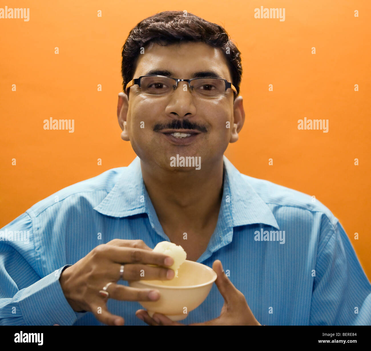Man eating a sweet Stock Photo - Alamy