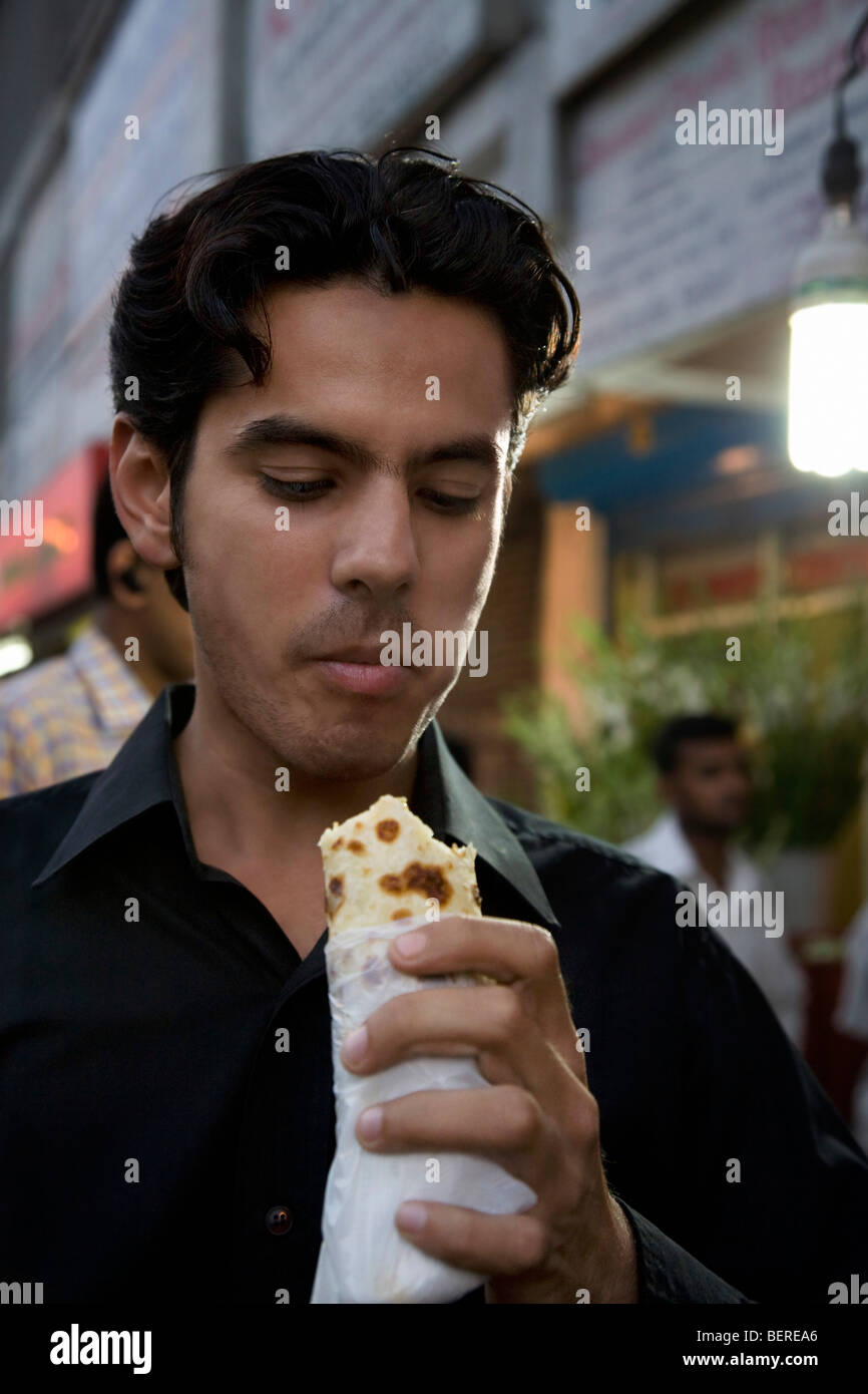 Man eating street food Stock Photo - Alamy