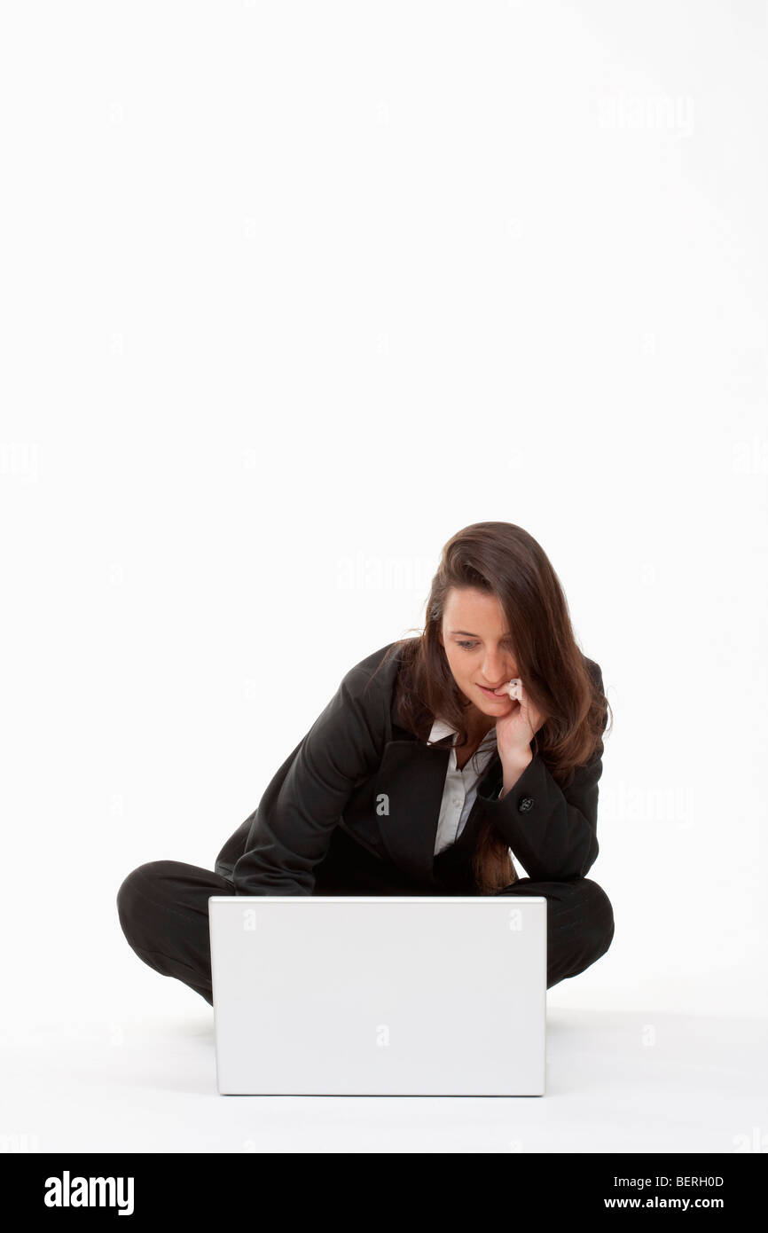 attractive young businesswoman working with laptop computer concerned ...