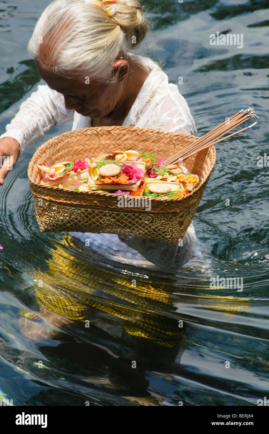 pilgrim taking a bath at the holy spring and temple of Tirta Empul in ...