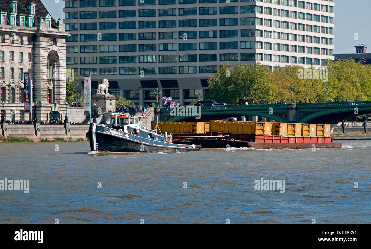 Tug Boat towing Container Cargo under the Westminster Bridge on River ...