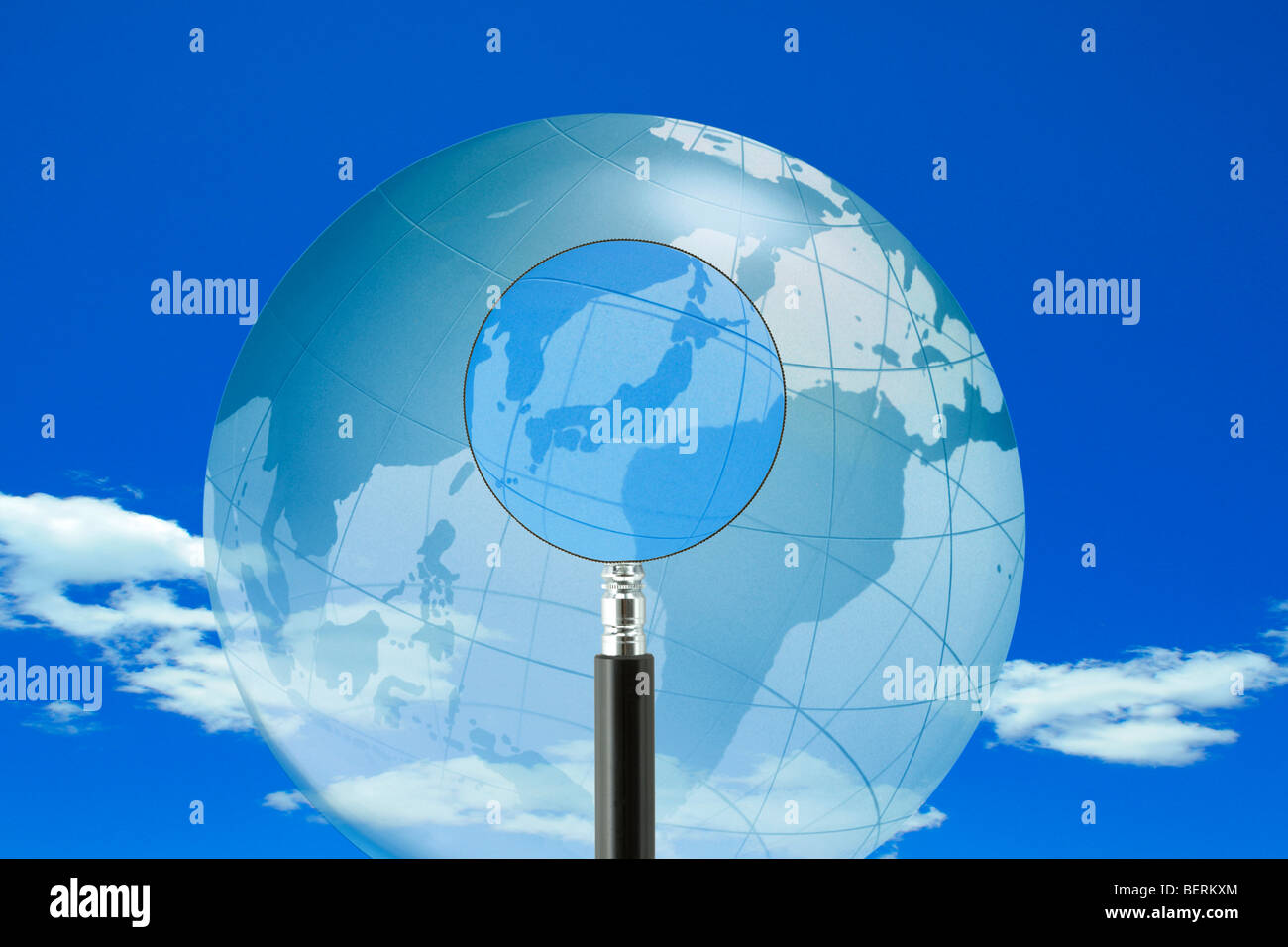 Magnifier and Globe in Blue Sky Stock Photo - Alamy