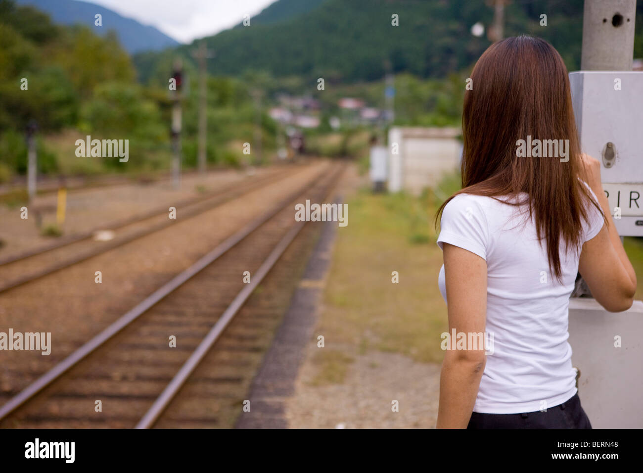 Young woman standing on platform Stock Photo - Alamy