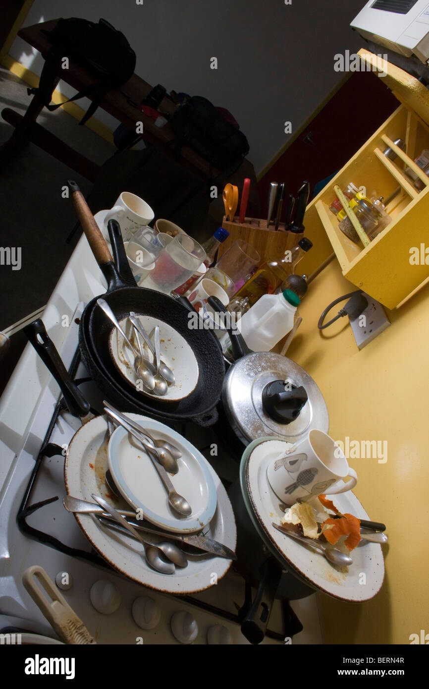 Untidy pile of dirty washing up on a hob Stock Photo - Alamy