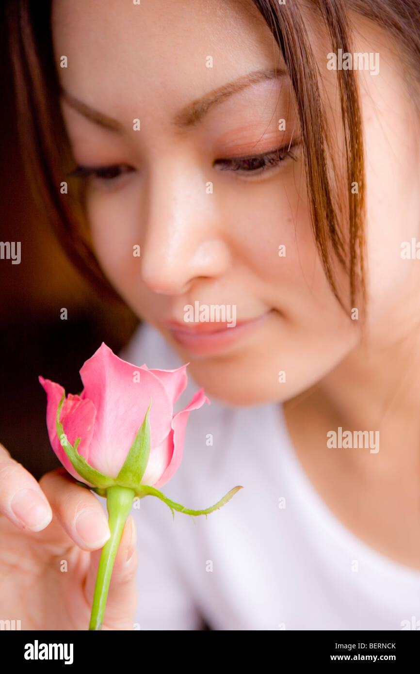 Woman smelling scented rose hi-res stock photography and images - Alamy