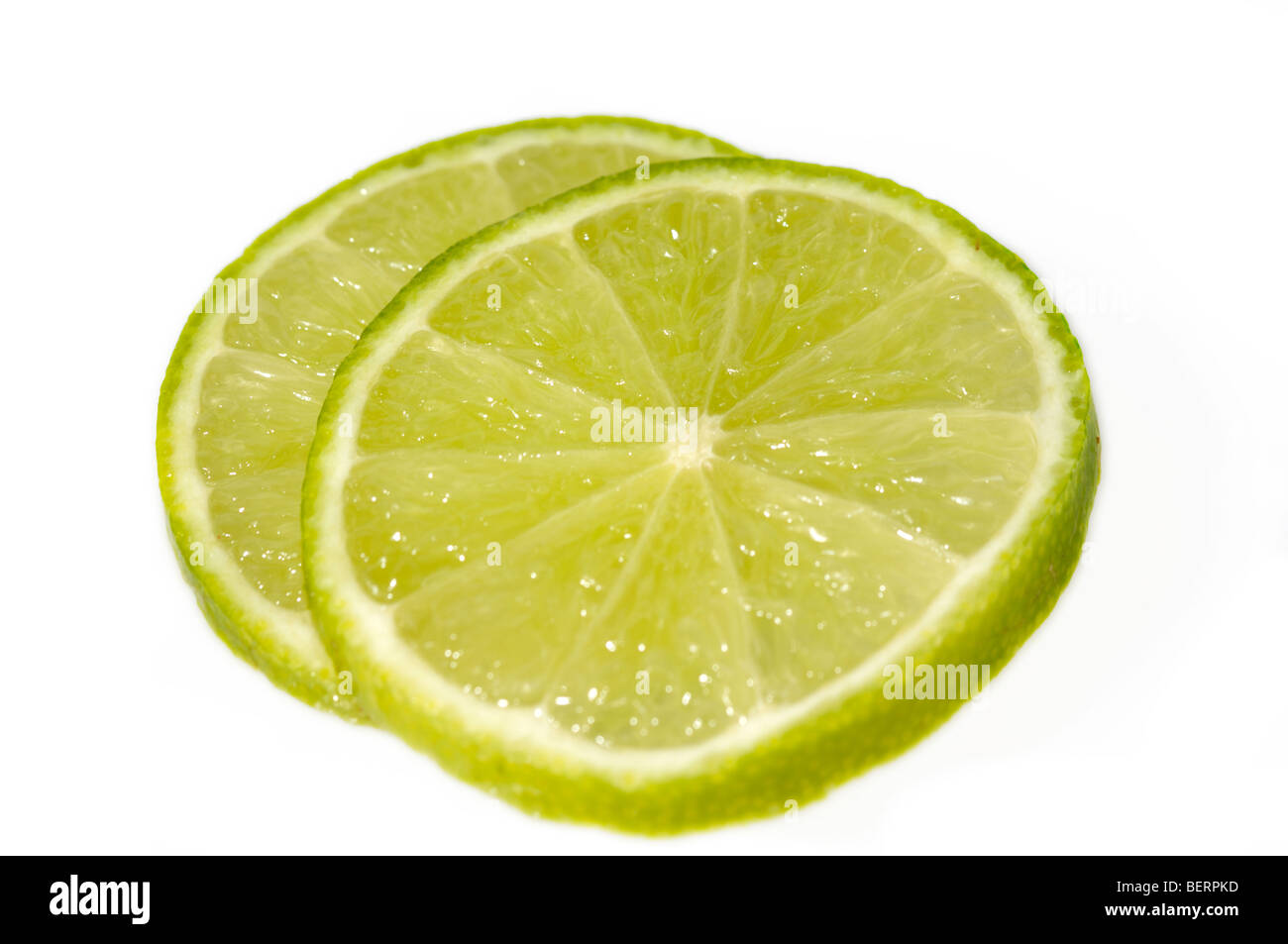 Two slices of Brazilian lime on white background Stock Photo - Alamy