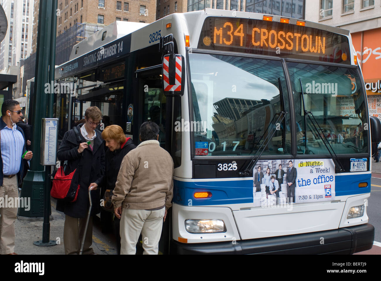 Riders board and exit a bus in Midtown Manhattan in New York Stock ...