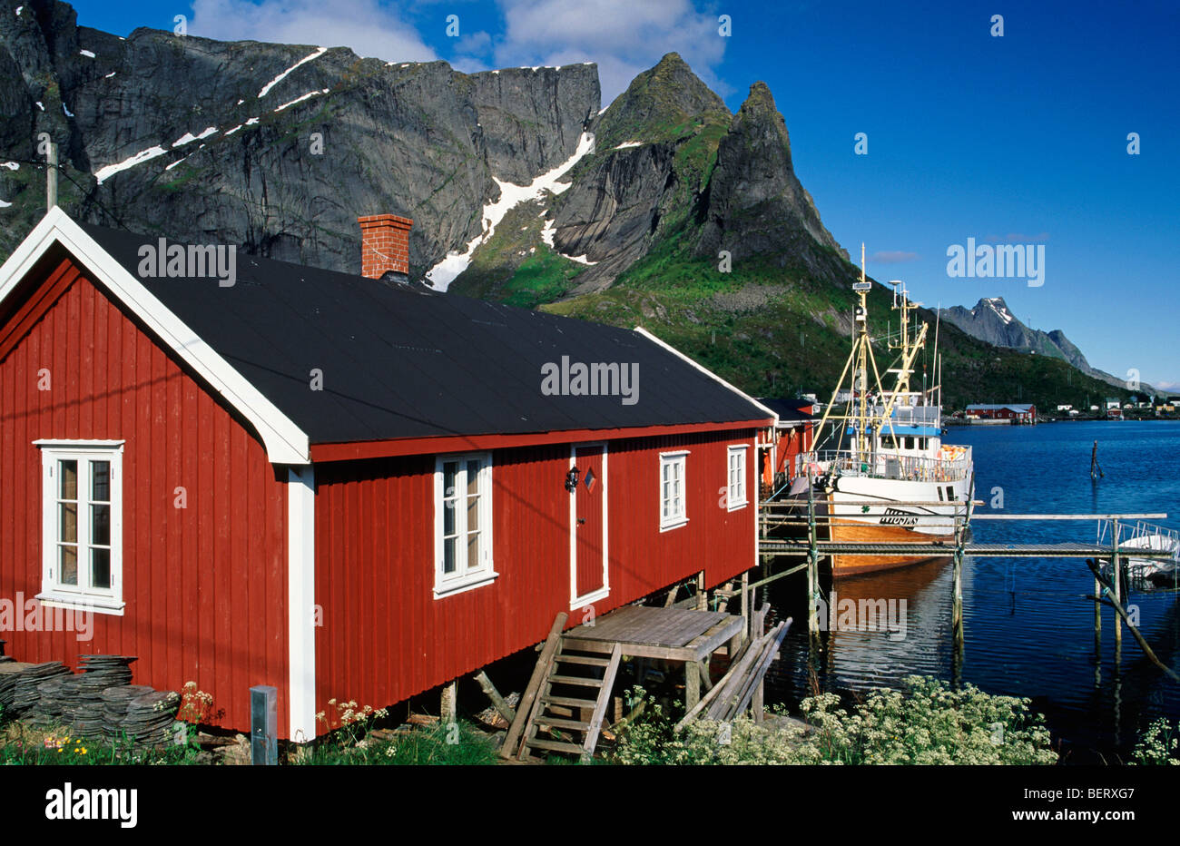 Fishing boat and typical red houses / robur cottages at fishing village ...