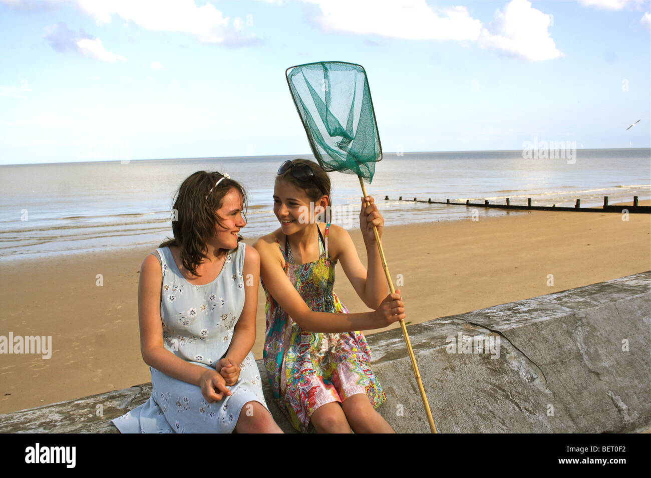 two kids on holiday at the seaside having fun Stock Photo - Alamy