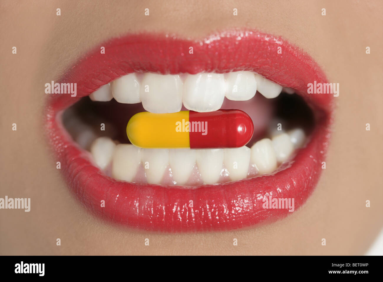 Beauty woman mouth with red lips and medicine pill Stock Photo - Alamy