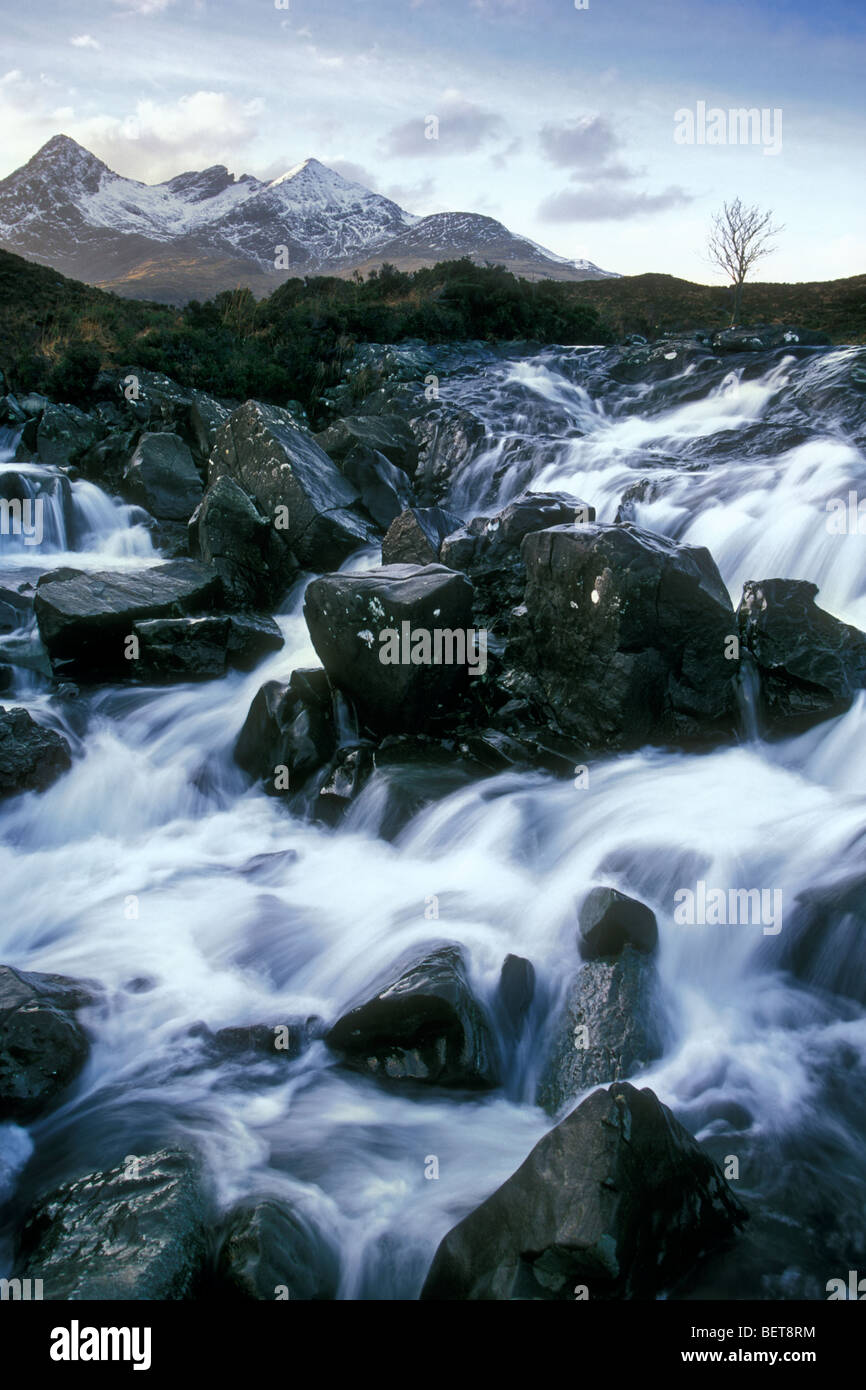 Mountain stream with waterfall and the Cuillin Hills in winter, Skye ...