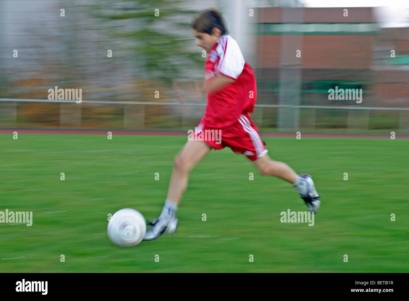 young boy playing football Stock Photo - Alamy