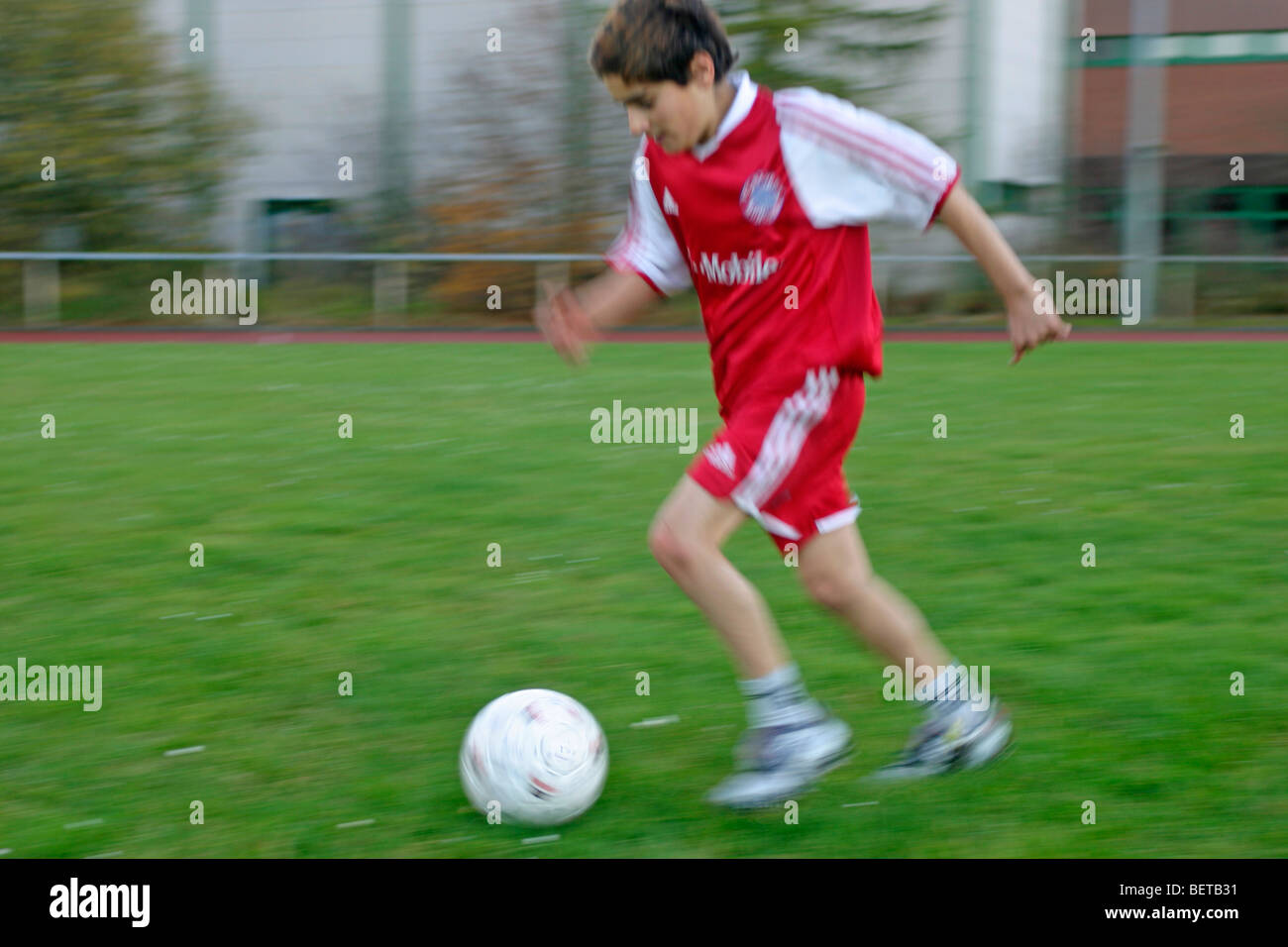 young boy playing football Stock Photo - Alamy