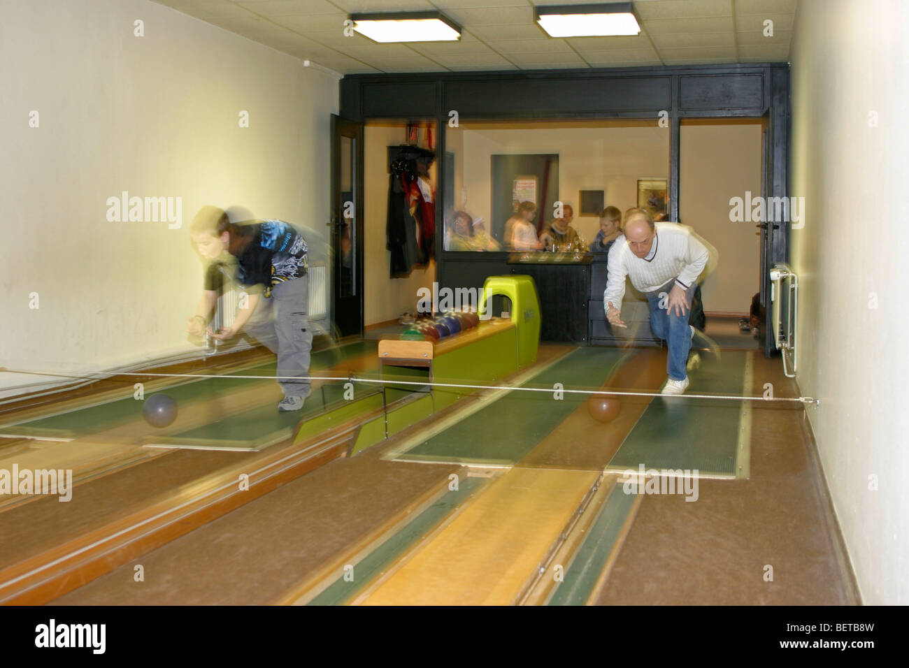 family playing at skittles Stock Photo - Alamy