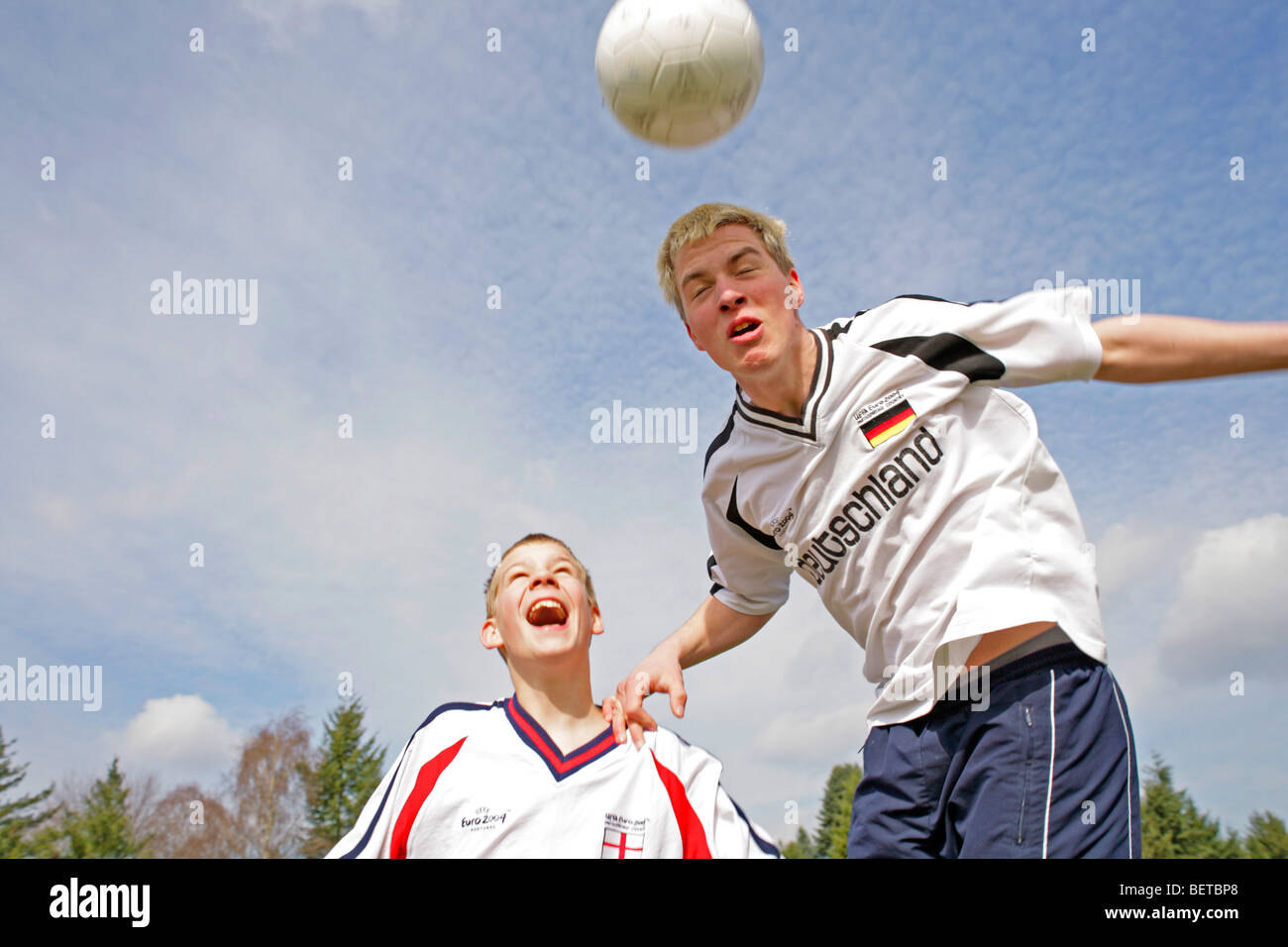Two boys header soccer ball hi-res stock photography and images - Alamy