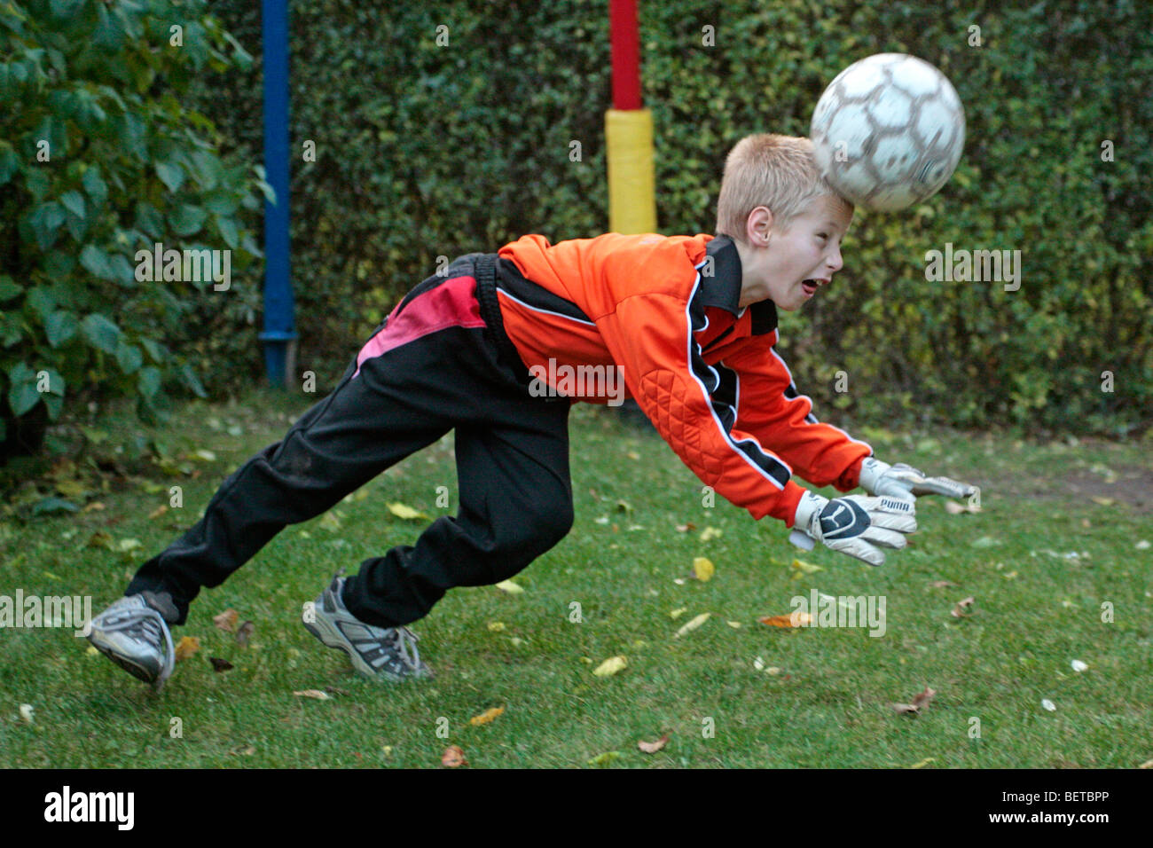 young boy playing football Stock Photo - Alamy