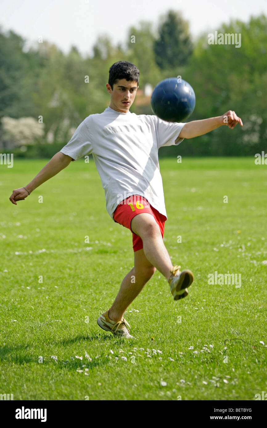 young boy playing football Stock Photo - Alamy