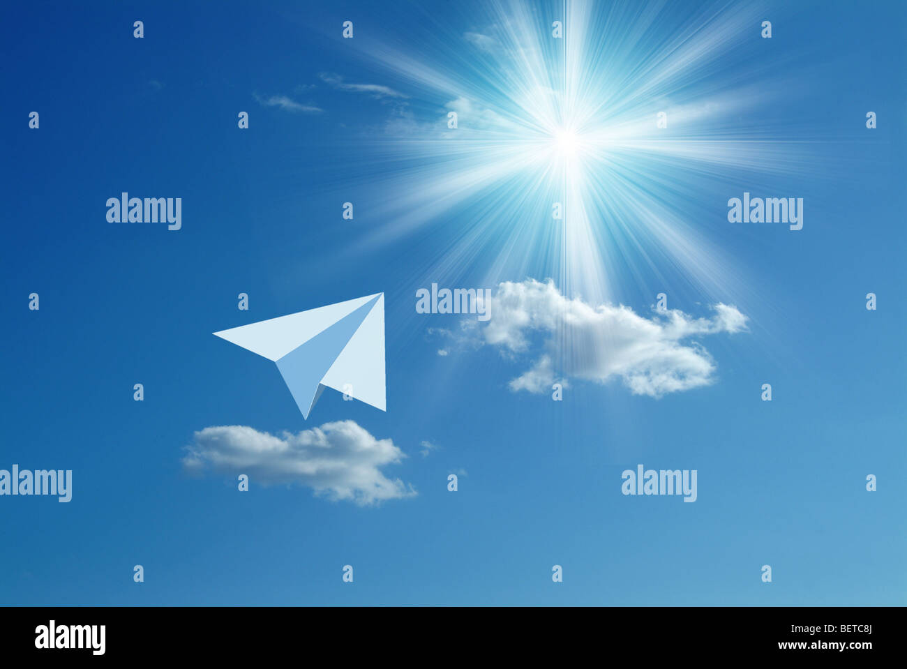 Paper airplane flying towards the sun Stock Photo - Alamy