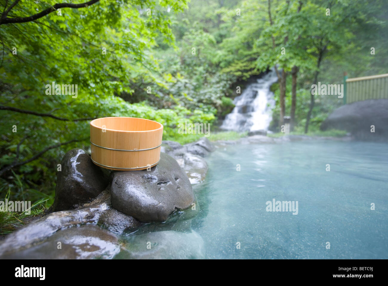 Bamboo bucket next to a forest hot spring Stock Photo - Alamy