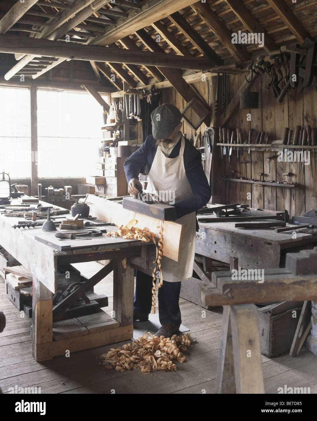 Carpenter planing wood in workshop Stock Photo - Alamy