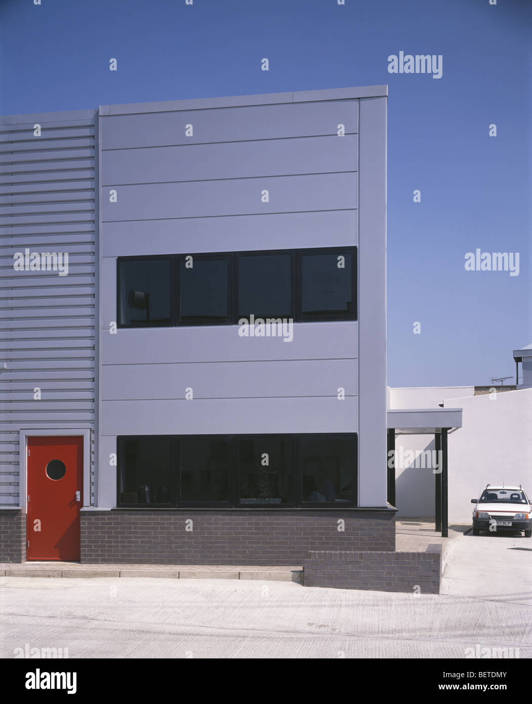 Small gray commercial office building Stock Photo - Alamy