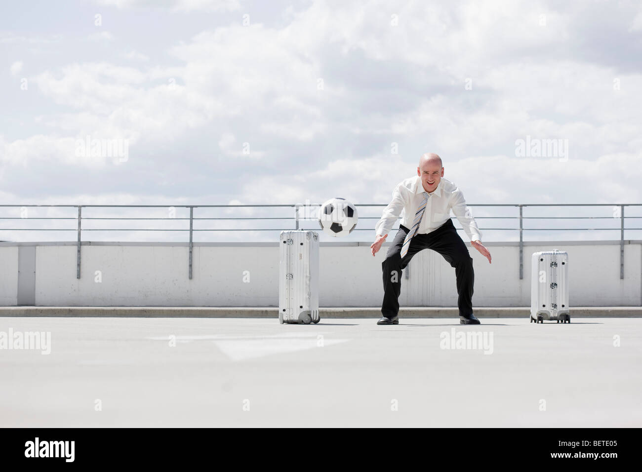 man playing football near car Stock Photo - Alamy