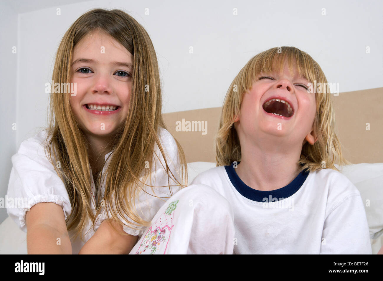 Young girl and boy laughing Stock Photo - Alamy