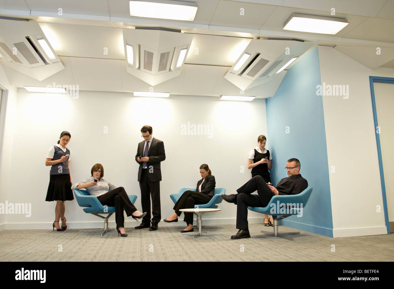 Portrait of a business group texting Stock Photo - Alamy