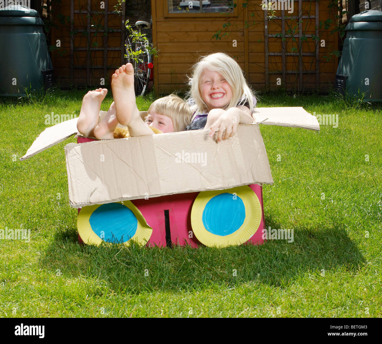 two young girls playing in cardboard box Stock Photo - Alamy