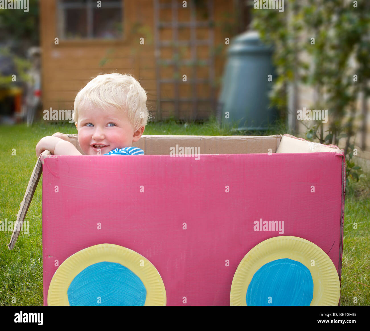 young boy standing in cardboard box Stock Photo - Alamy