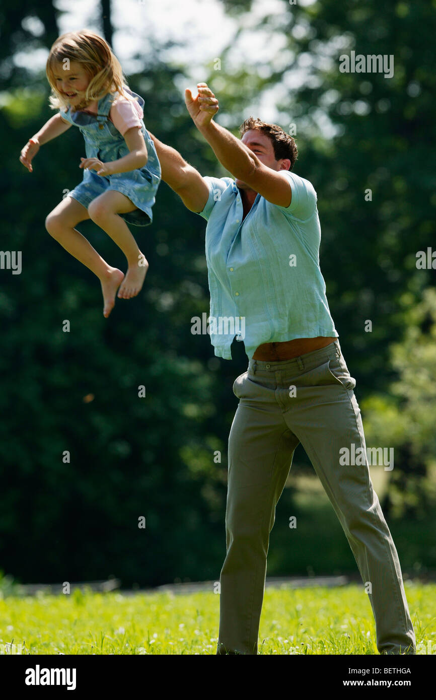 father in the park catching his daughter Stock Photo - Alamy