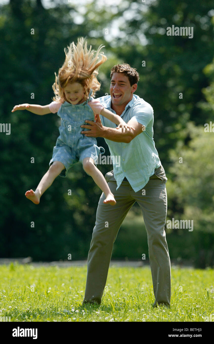 father in the park catching his young daughter Stock Photo - Alamy