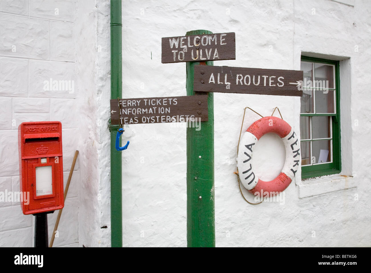 Signs on the jetty, red letterbox, white cottage Stock Photo - Alamy